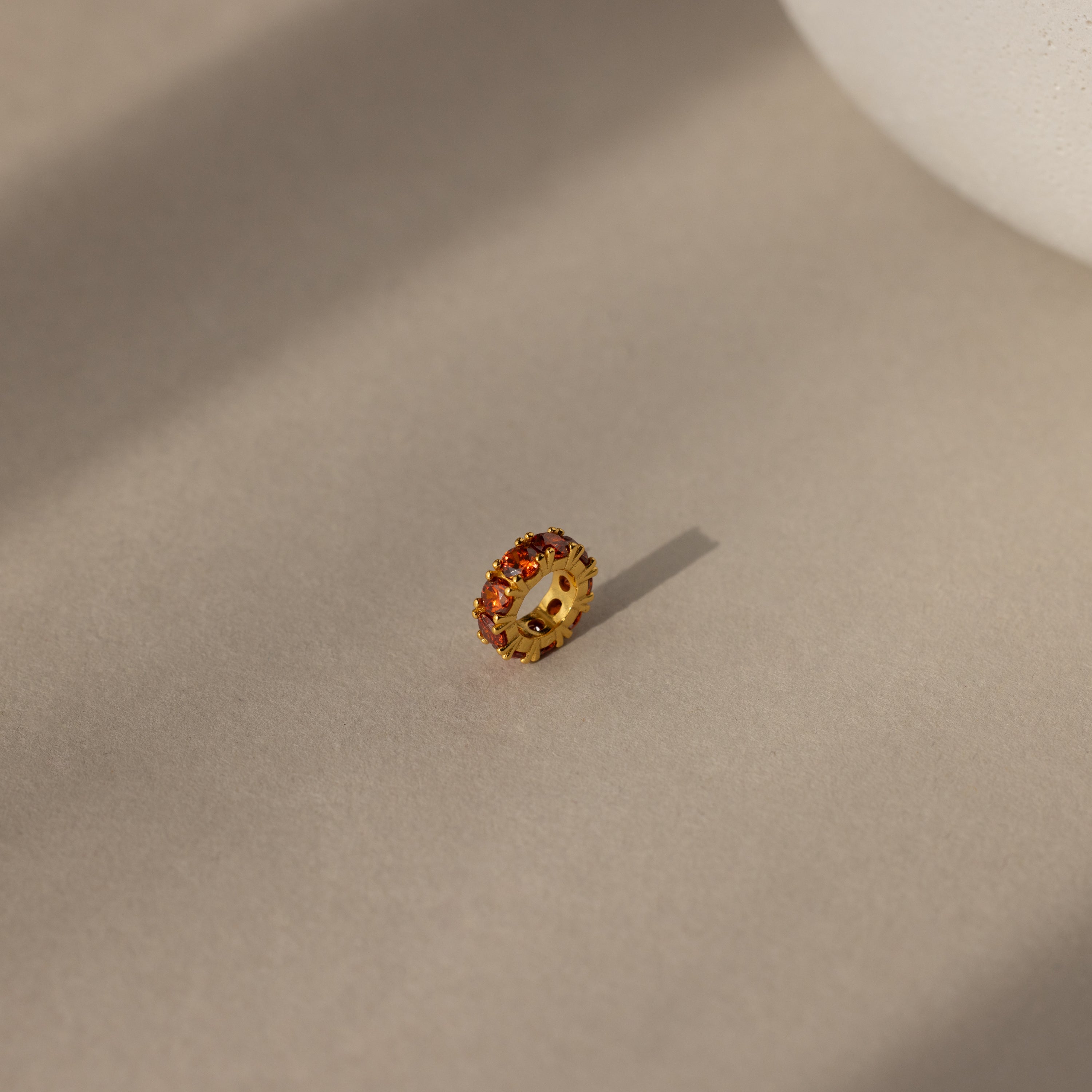 Infinity Circle Garnet Birthstone Charm in 18K Gold | Caitlyn Minimalist